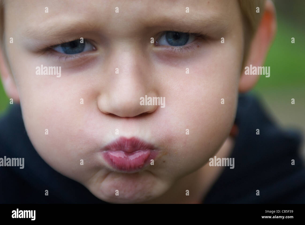 Close up portrait of blond boy making a face Stock Photo - Alamy