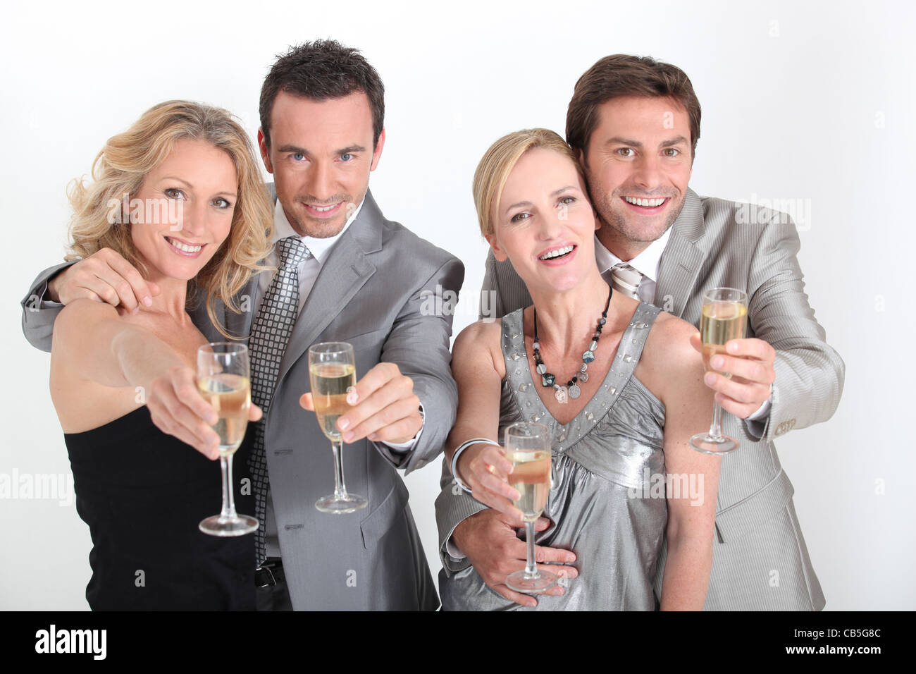 Four people celebrating Stock Photo - Alamy