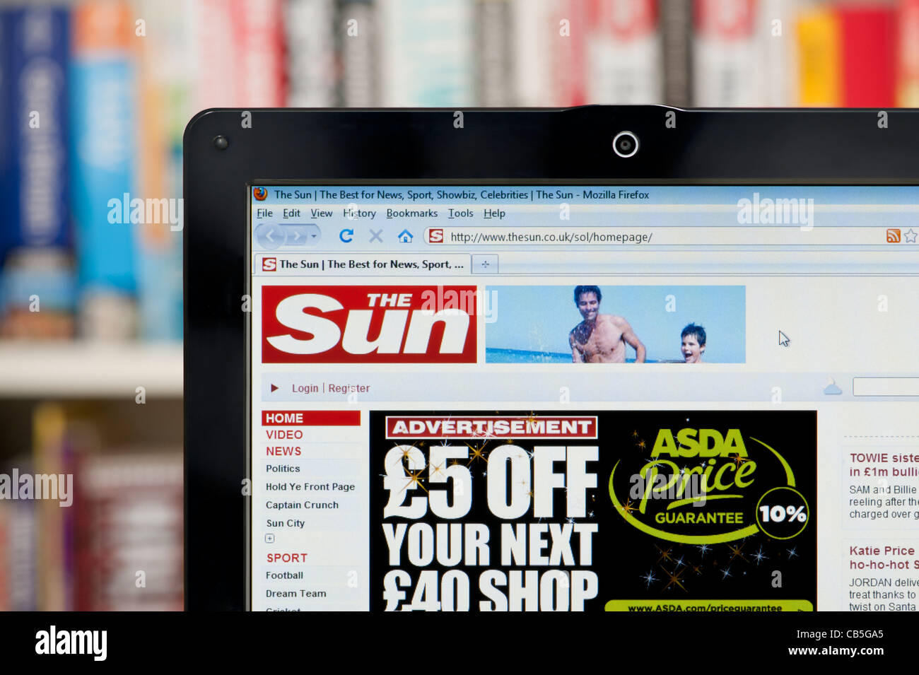 The Sun newspaper website shot against a bookcase background (Editorial ...