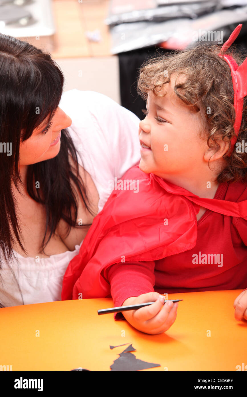 mother and cute child disguised as devil Stock Photo - Alamy