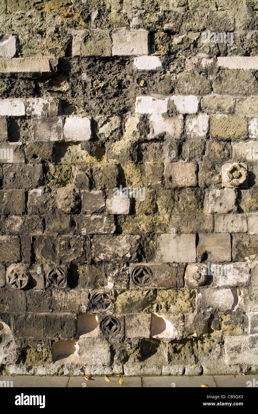 Old stone wall displaying a mix of new, and old weathered stone with ...