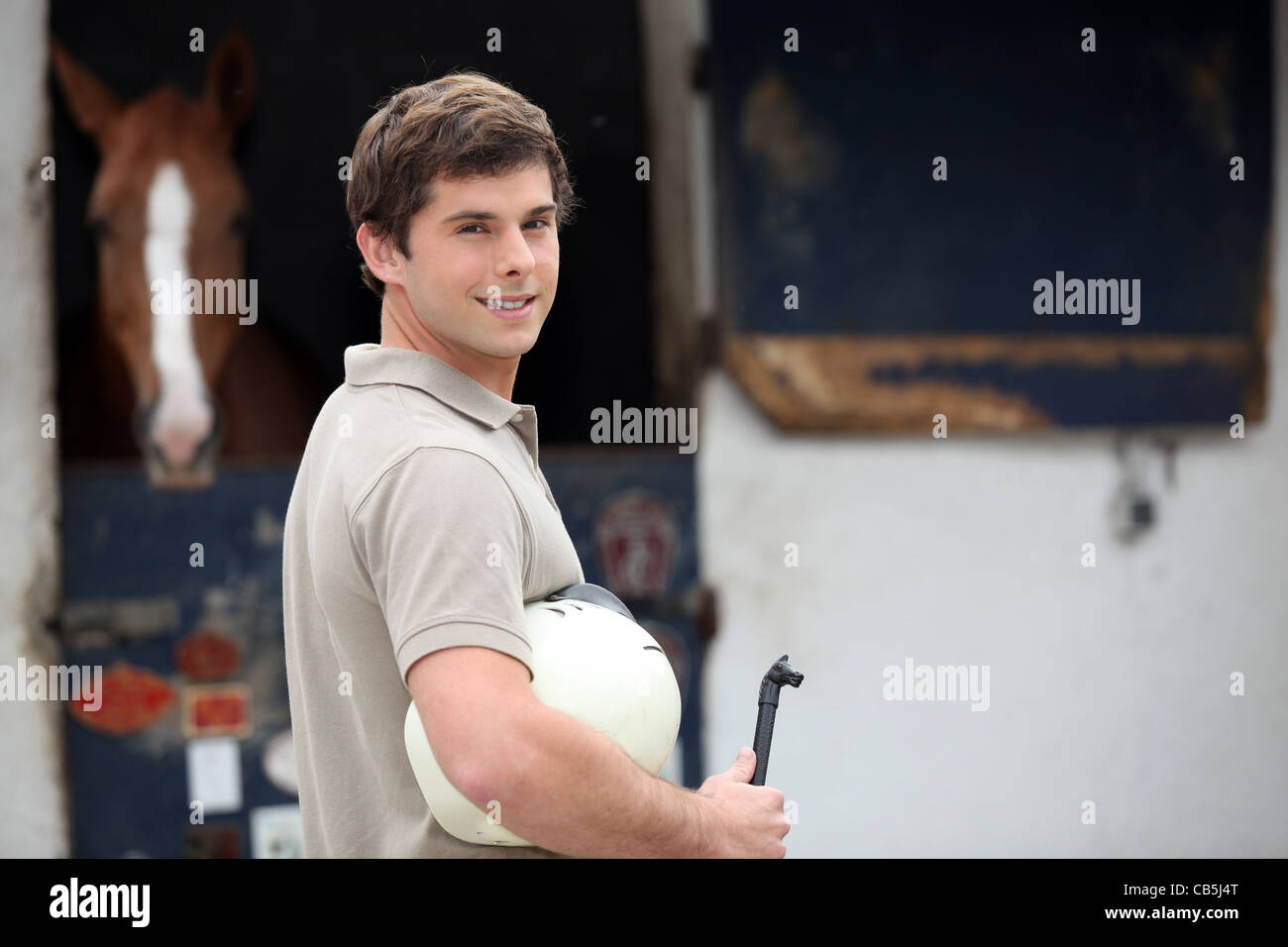 Young man at a riding stables Stock Photo - Alamy