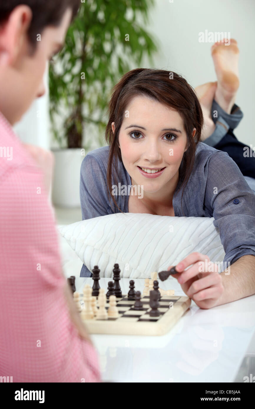 Young woman playing chess Stock Photo - Alamy