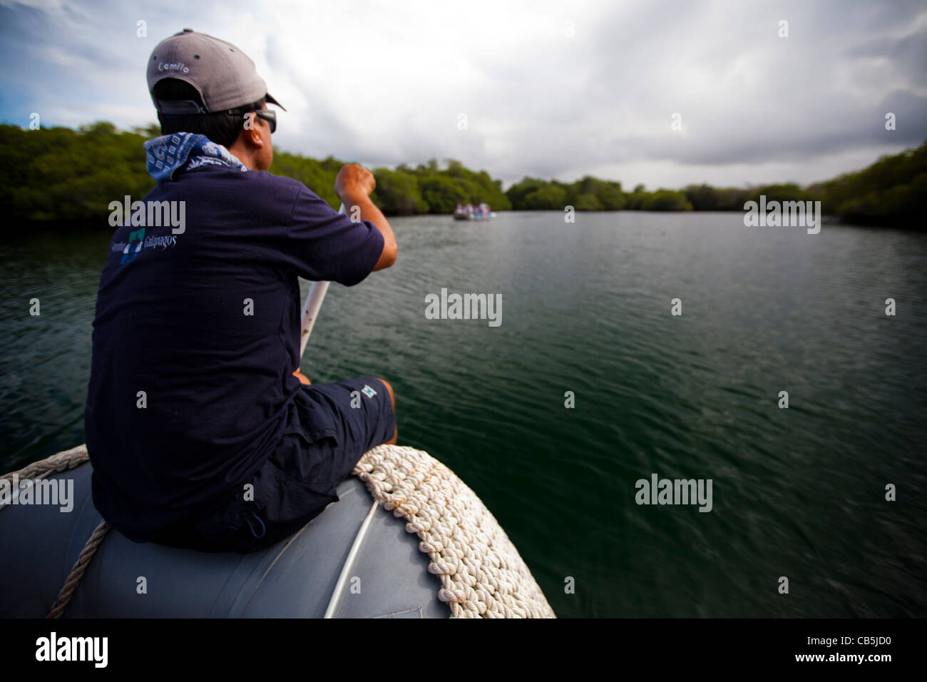 galapagos dingy swamp paddle guide cloudy water Stock Photo - Alamy