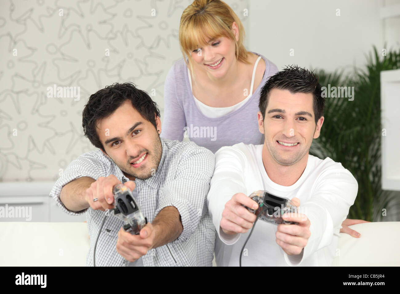 Friends playing video games Stock Photo - Alamy
