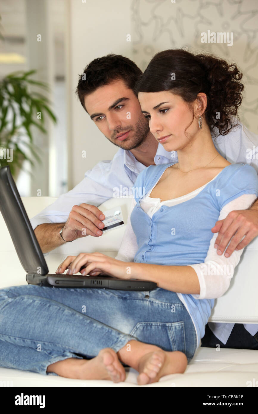 Couple surfing the inter on sofa Stock Photo - Alamy