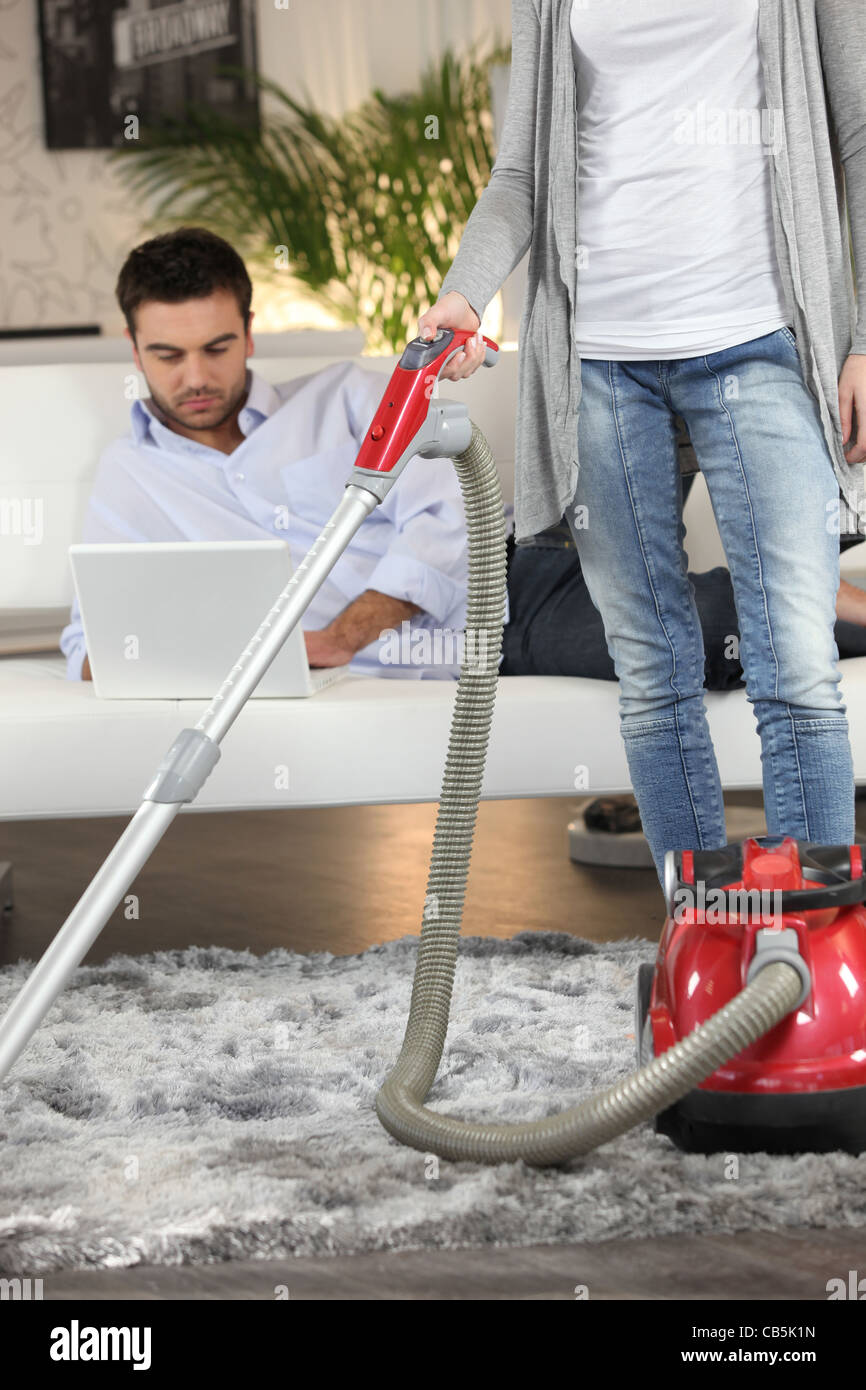 Woman vacuuming rug Stock Photo - Alamy