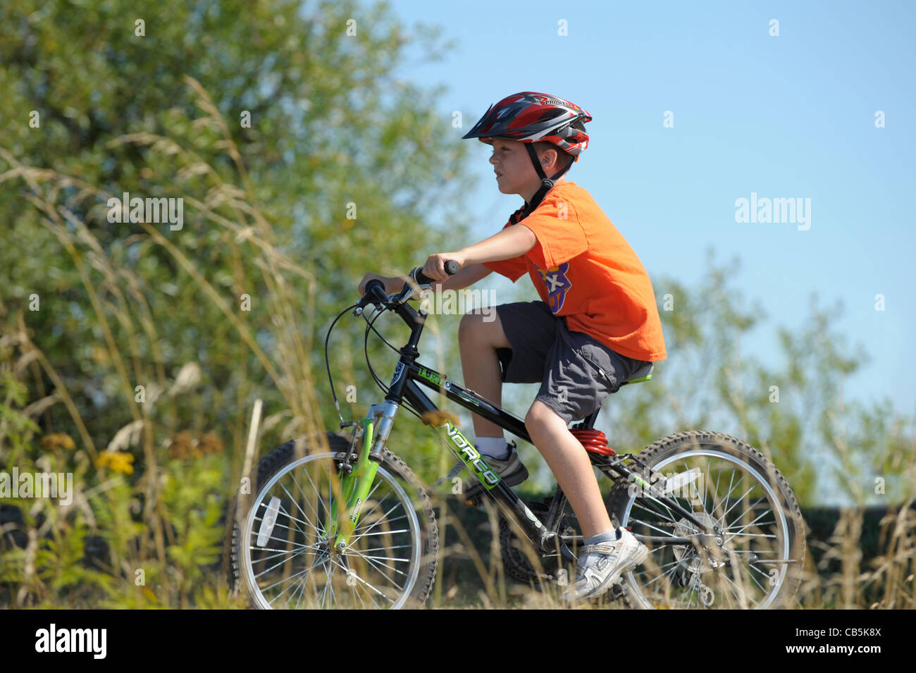 Boy with helmet on the bike Stock Photo - Alamy