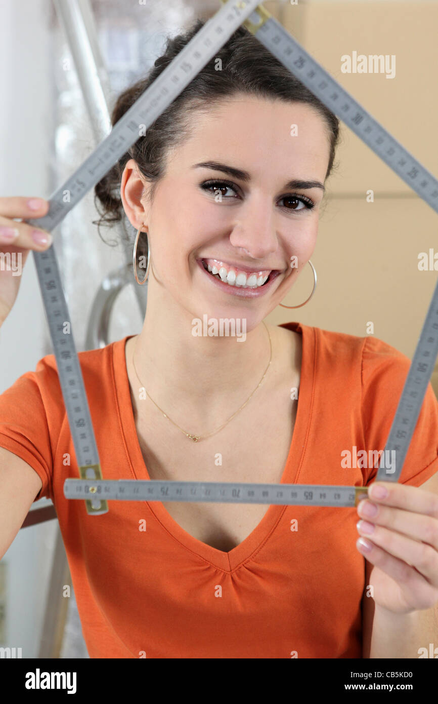 Woman using measuring device Stock Photo - Alamy
