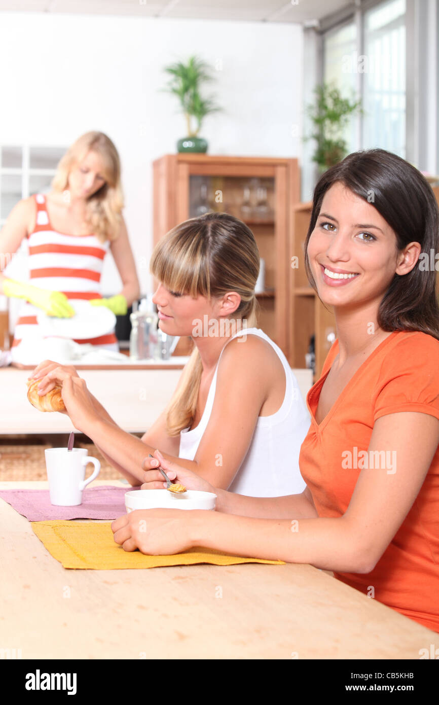 Young women having breakfast together Stock Photo - Alamy