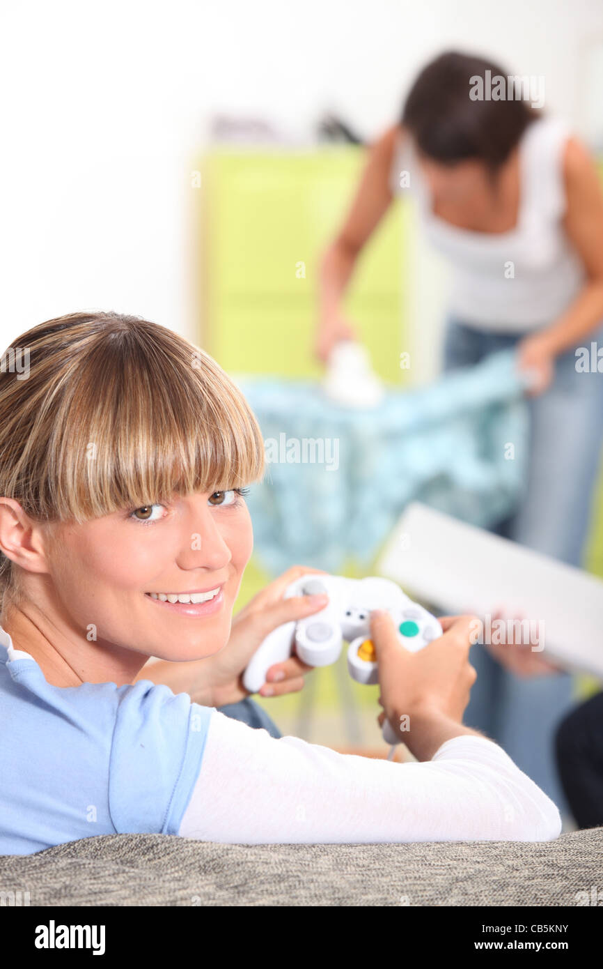 Lazy housemate playing video games Stock Photo - Alamy