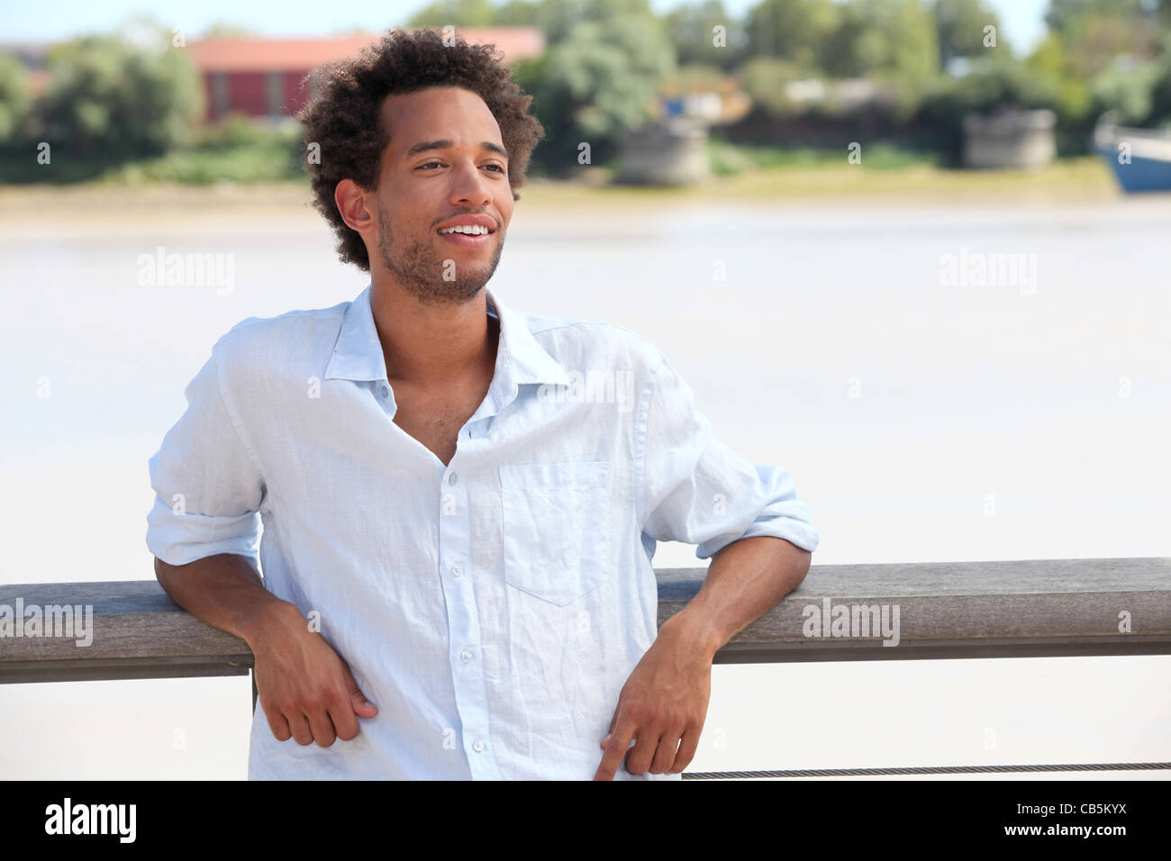 Man stood by riverfront Stock Photo - Alamy