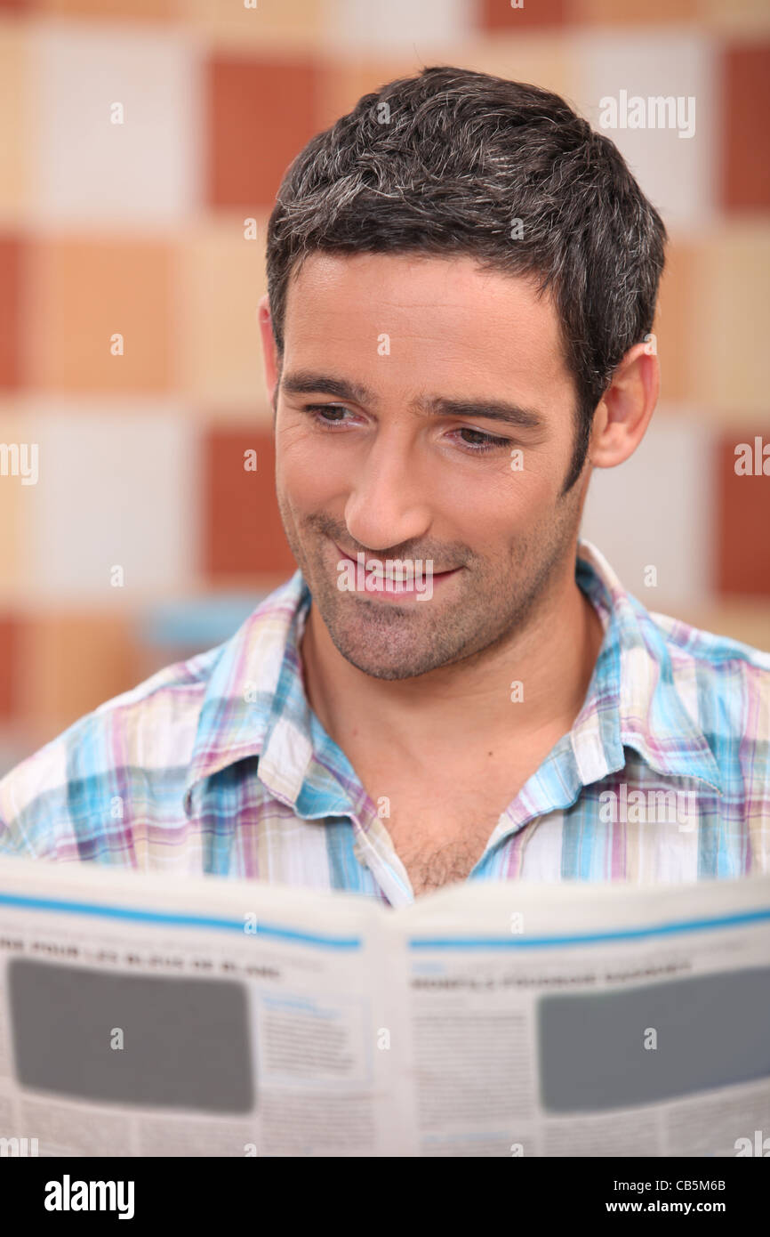 35 years old man reading newspaper Stock Photo - Alamy