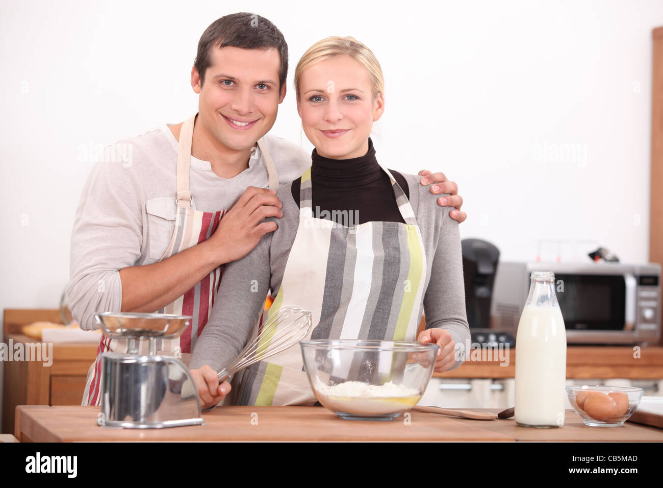 Couple baking together Stock Photo - Alamy