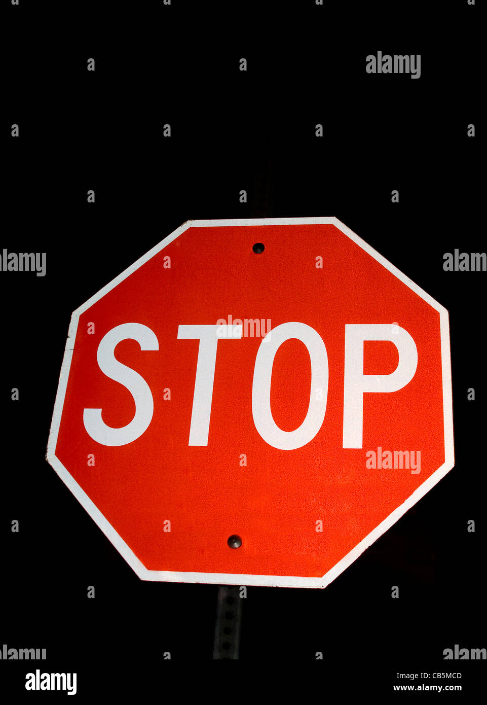 Bright Red Stop Sign at night Stock Photo - Alamy
