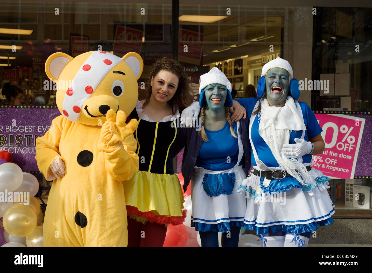 group of people dressed in costume collecting charity money for ...