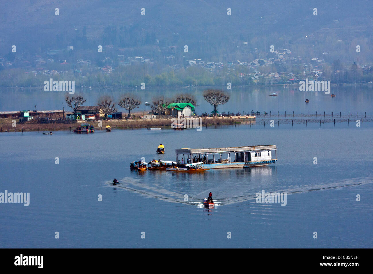 Dal lake of Srinagar with houseboats and speed boats carrying tourists ...