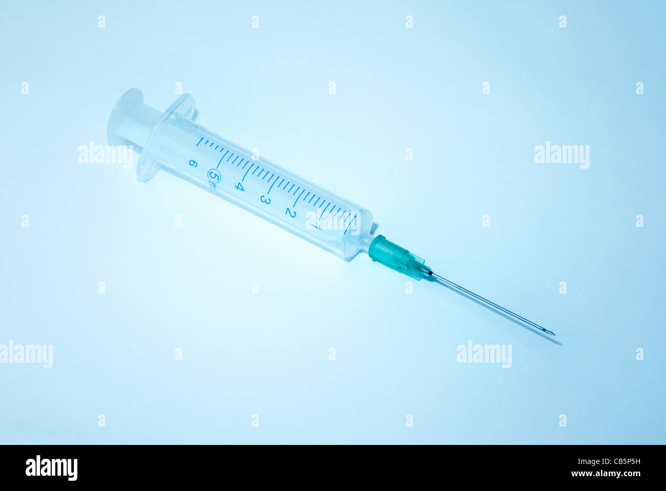 syringe focus on the needle,special blue light f/x Stock Photo - Alamy