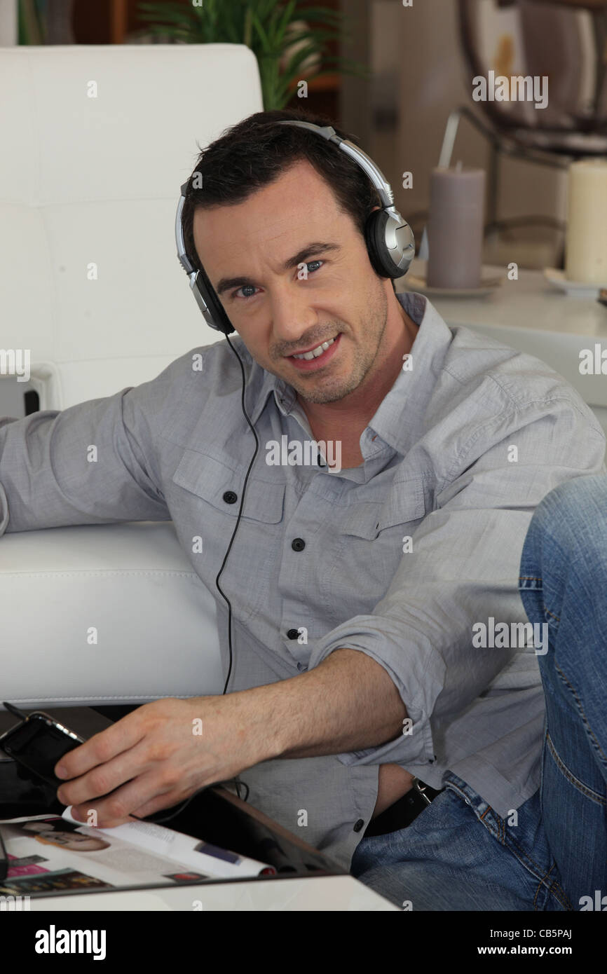 Smiling man listening to music Stock Photo - Alamy