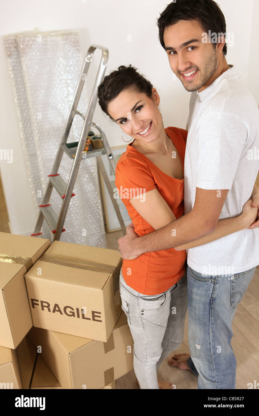 Couple with boxes marked fragile Stock Photo - Alamy