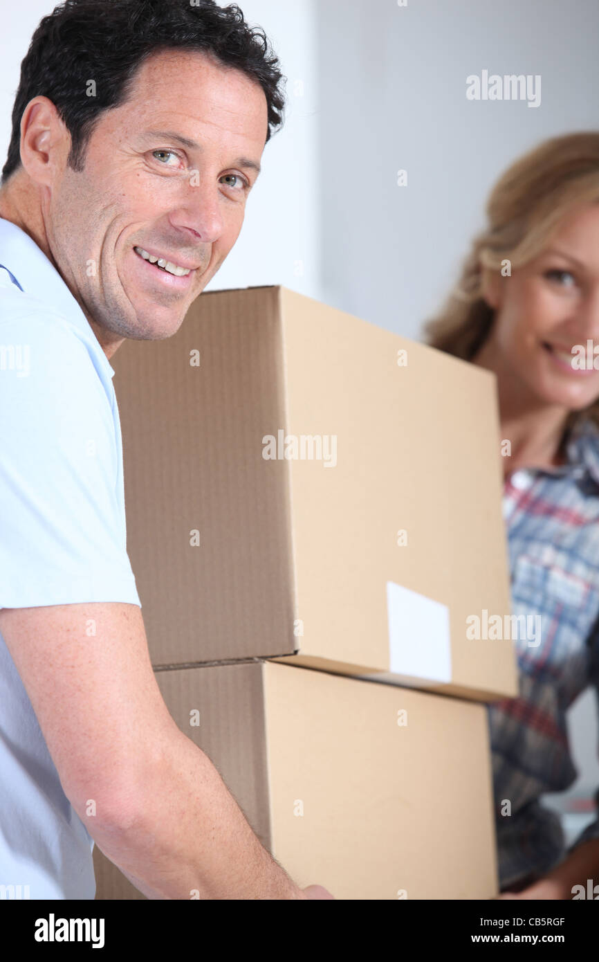Couple carrying boxes Stock Photo - Alamy