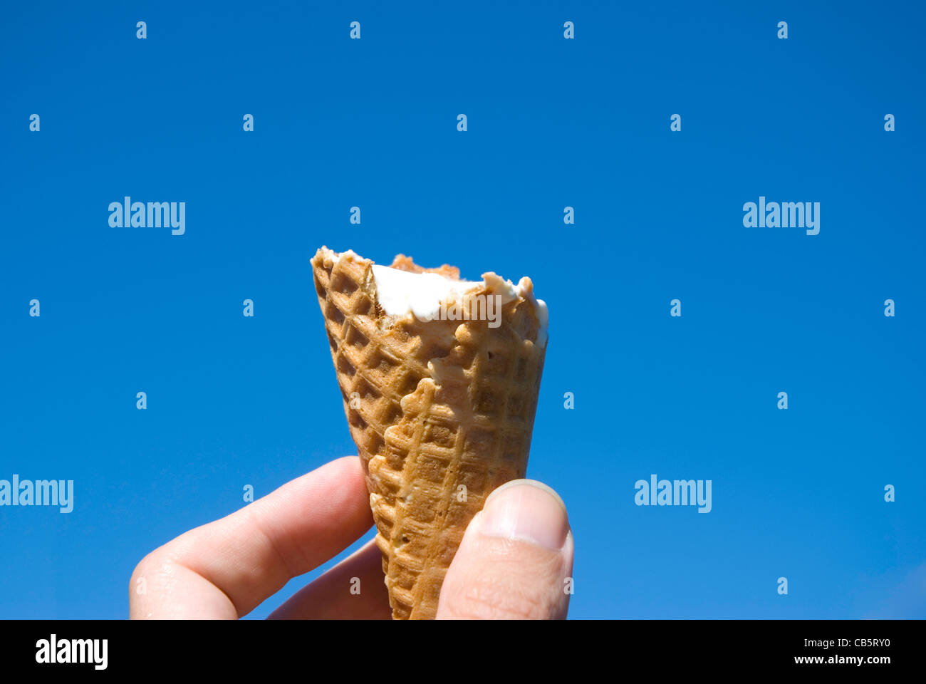 summer concept, ice--cream inn the hand on blue sky background Stock ...