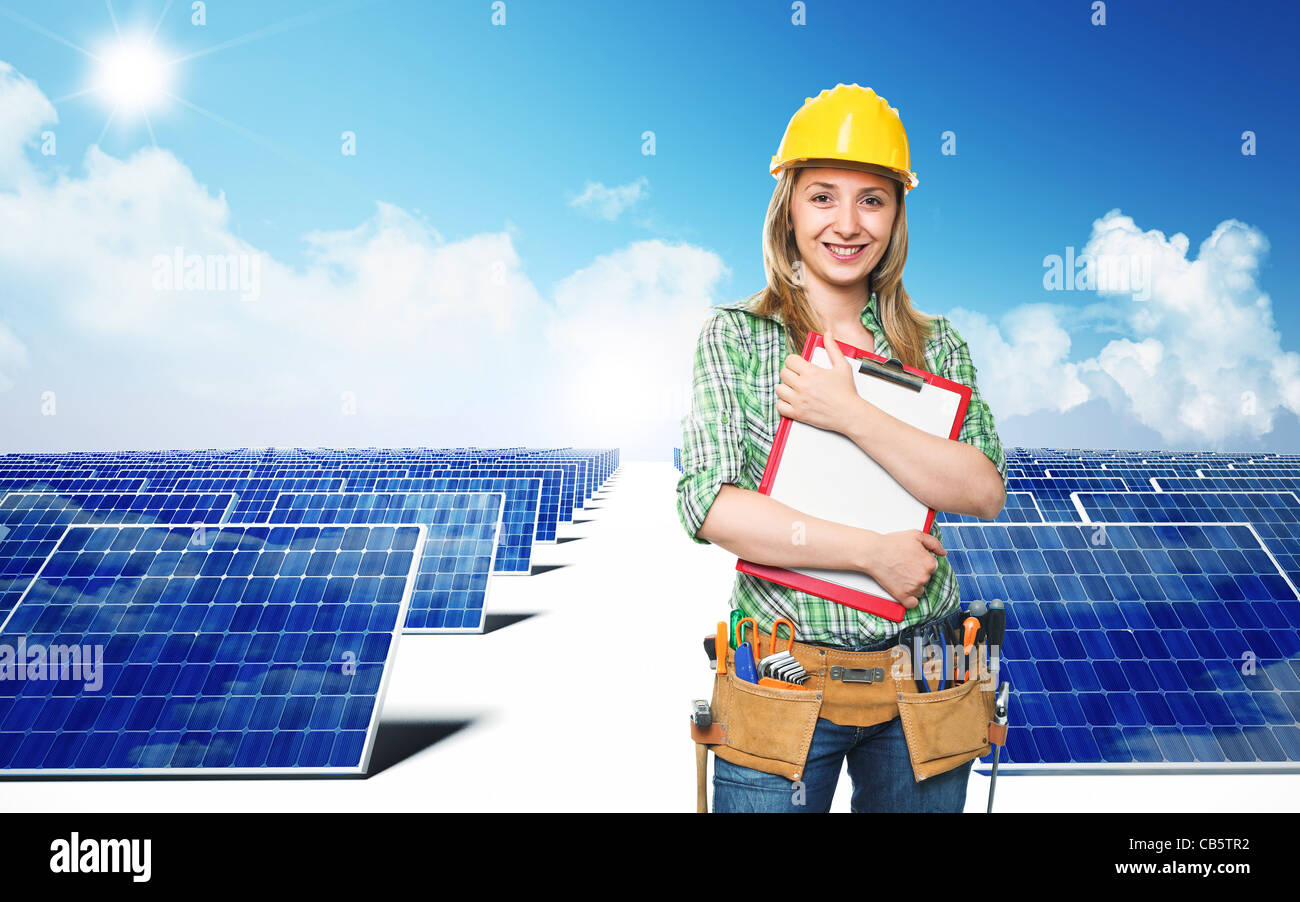 smiling engineer and solar panel background Stock Photo - Alamy