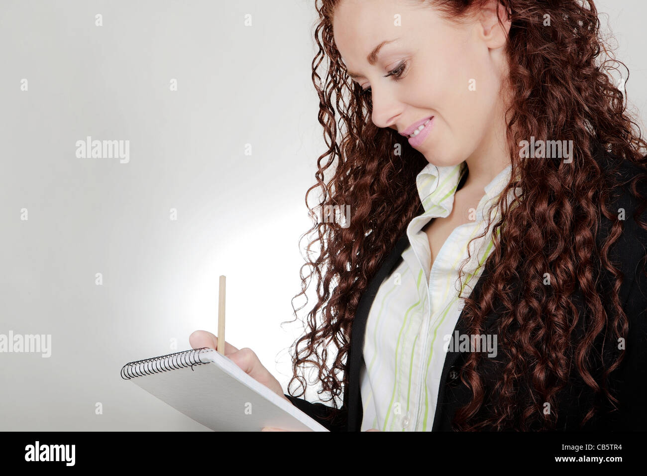 business woman holding a notepad Stock Photo - Alamy