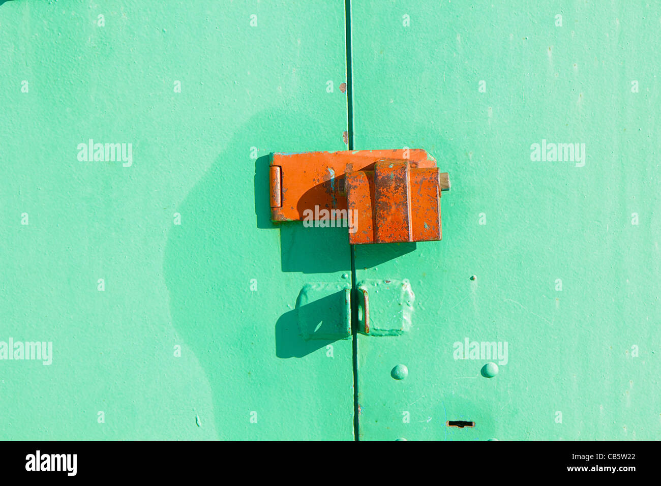 lock on the metal door painted with green paint Stock Photo - Alamy