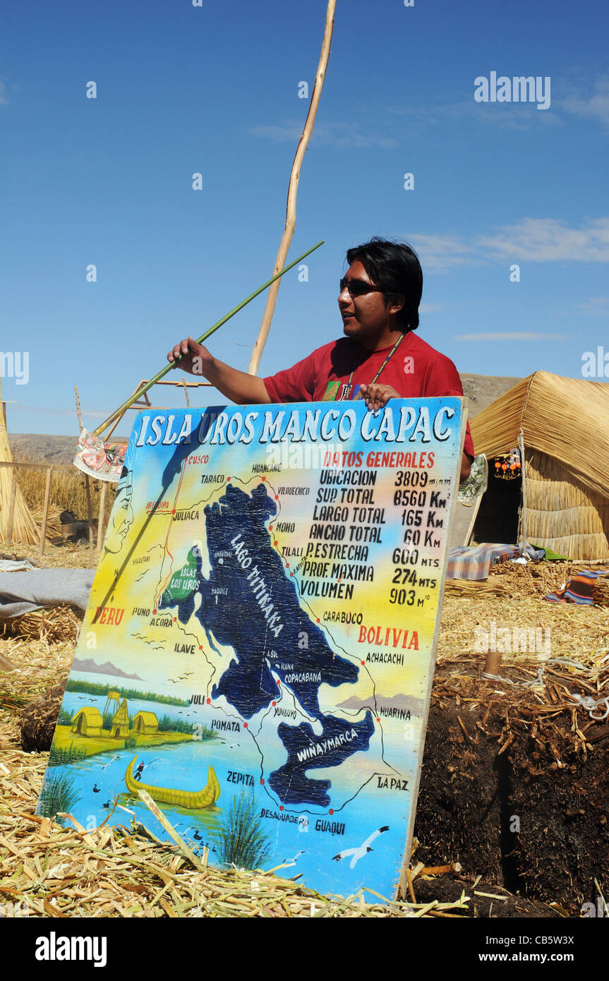 A Uros Islands tour guide showing a large map of Lake Titicaca Stock ...