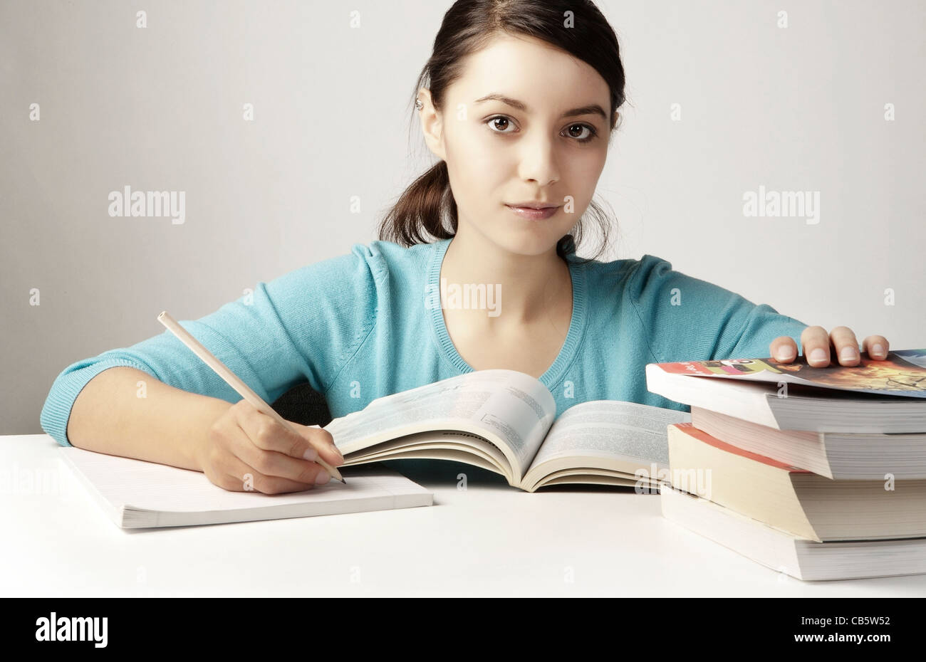 young good looking girl working hard over text books Stock Photo - Alamy