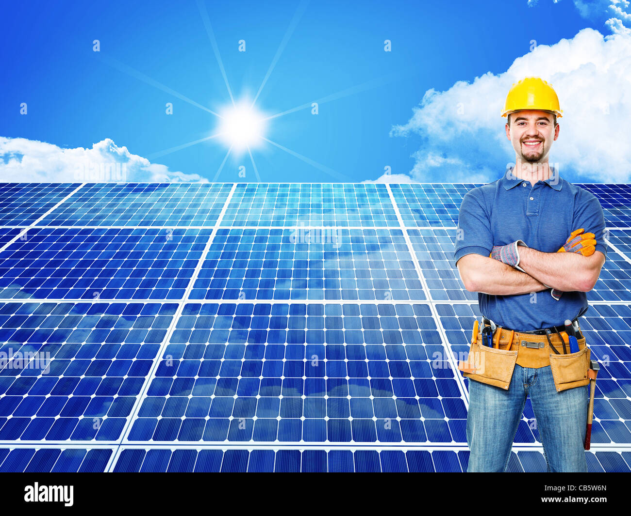standing worker and solar panel background Stock Photo - Alamy