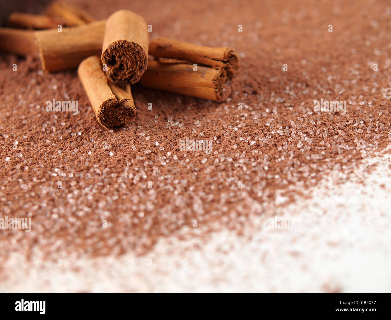 cinnamon sticks over cocoa powder Stock Photo - Alamy