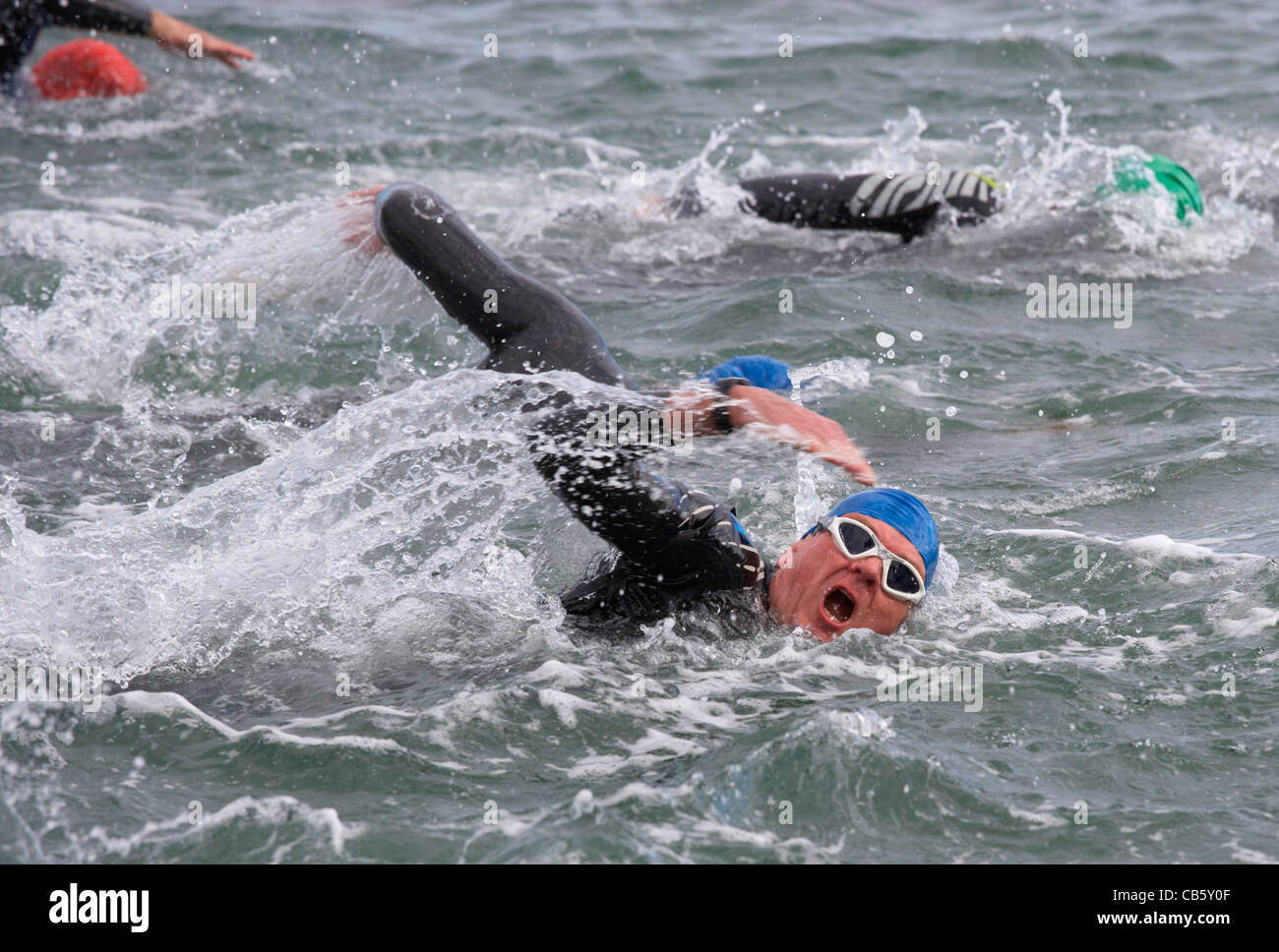 Swimming in a triathlon on the North Norfolk Coast Stock Photo - Alamy