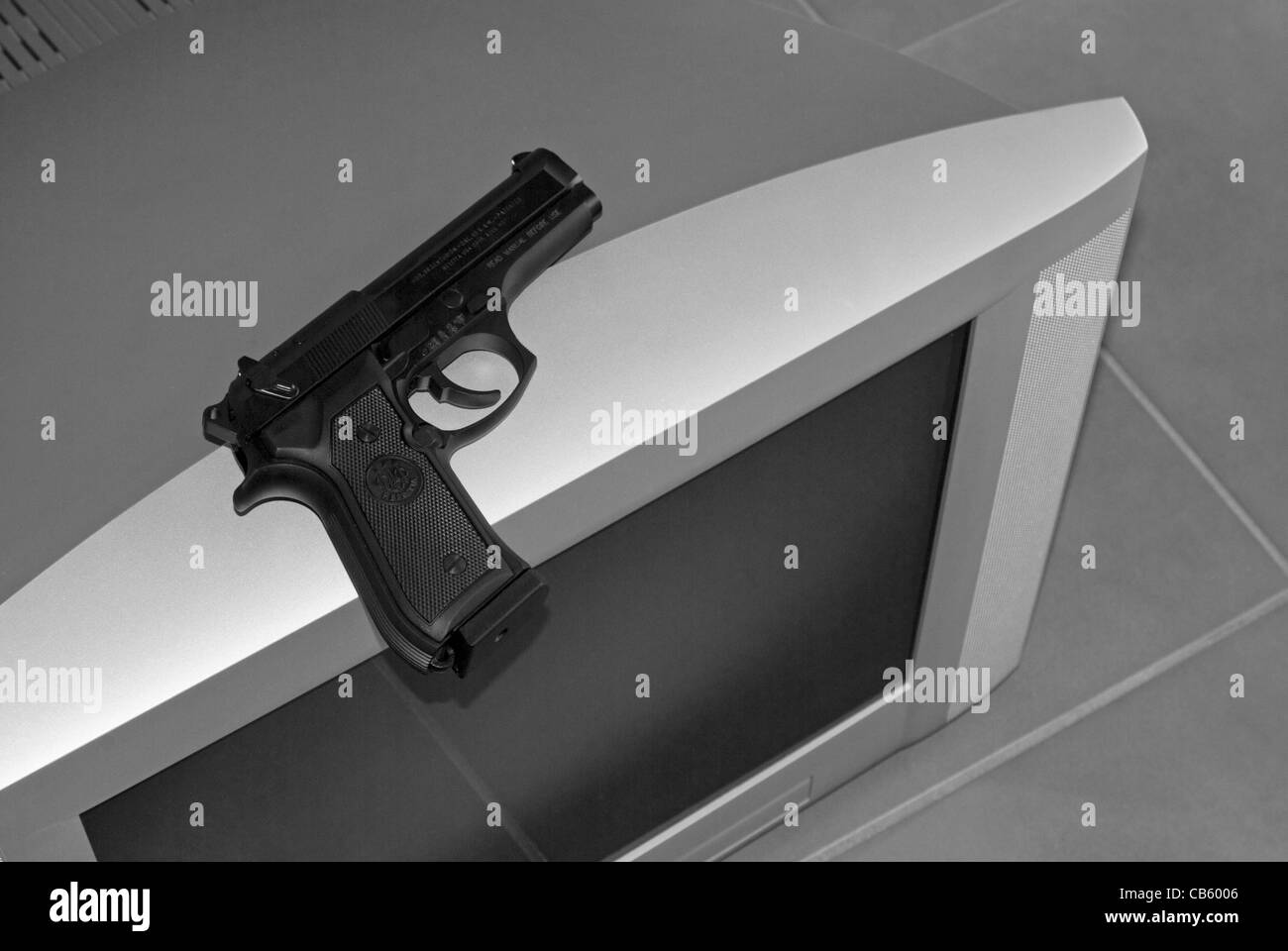 Beretta automatic handgun over television Stock Photo - Alamy
