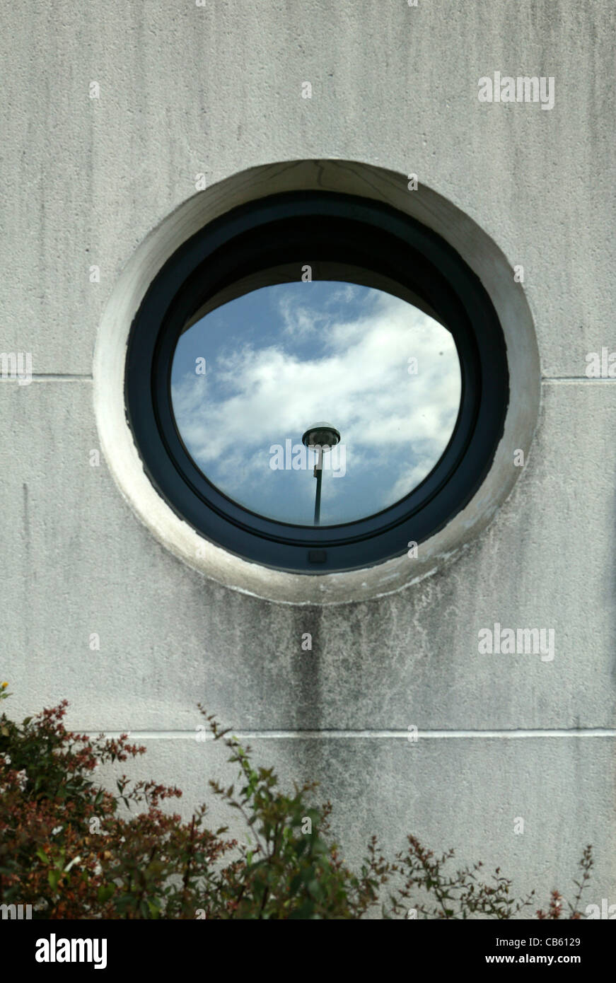 Circular window in an office building wall, in France Stock Photo - Alamy