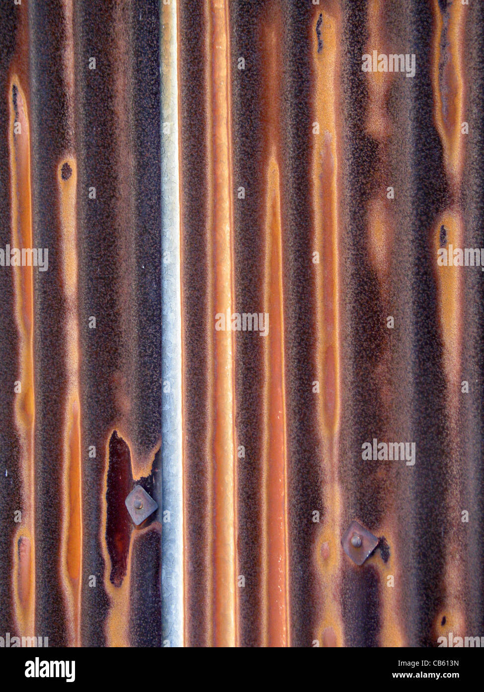Rusted corrugated iron panel behind old commercial buildings in London ...