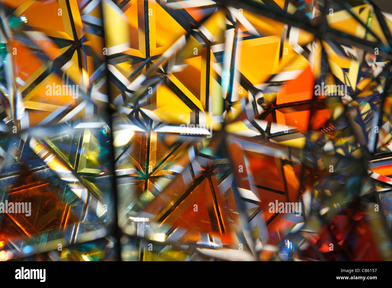 Crystal light shade with refracted coloured lights filtering through it ...