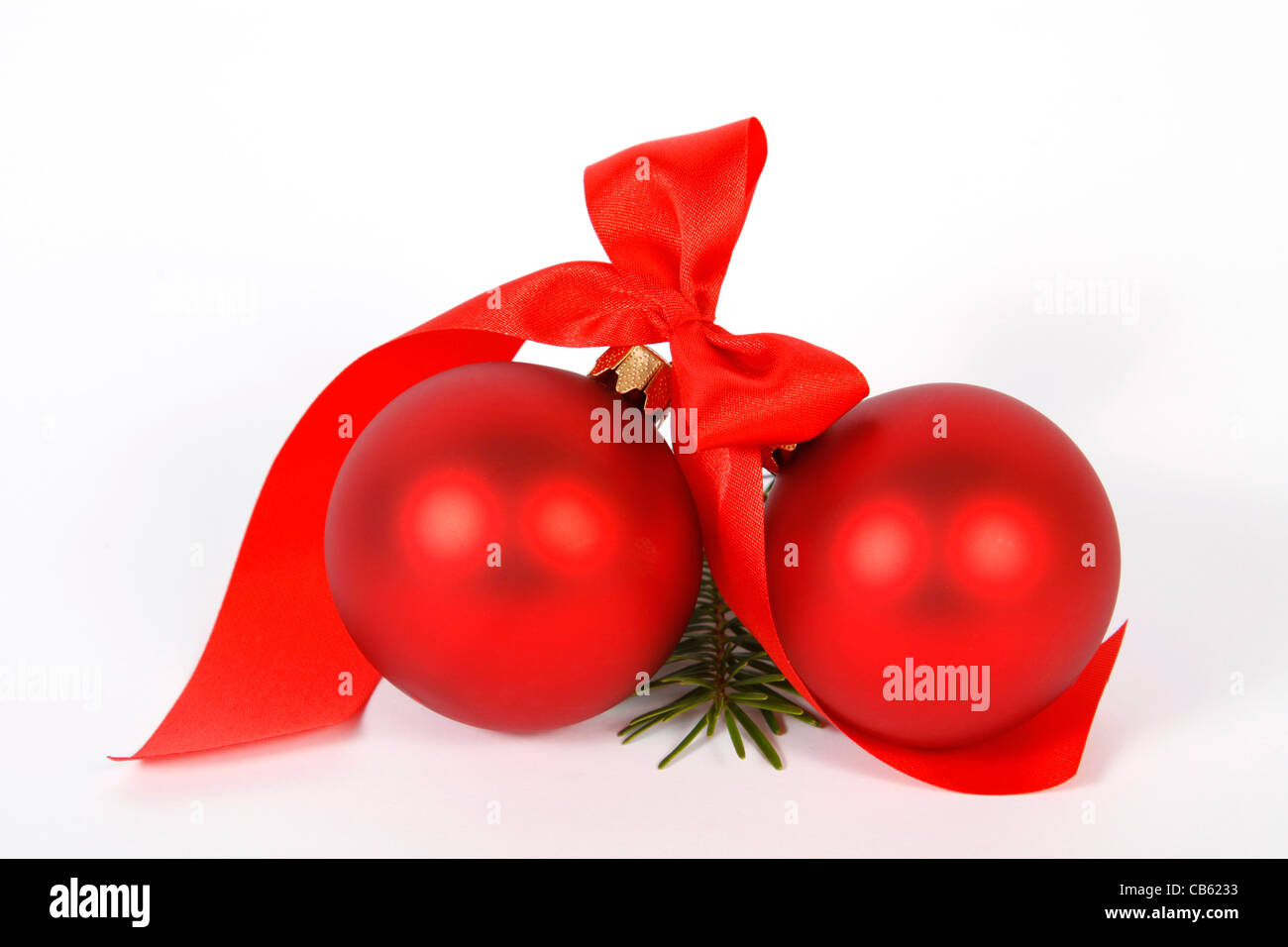 Red baubles with the ribbon on the white background Stock Photo - Alamy