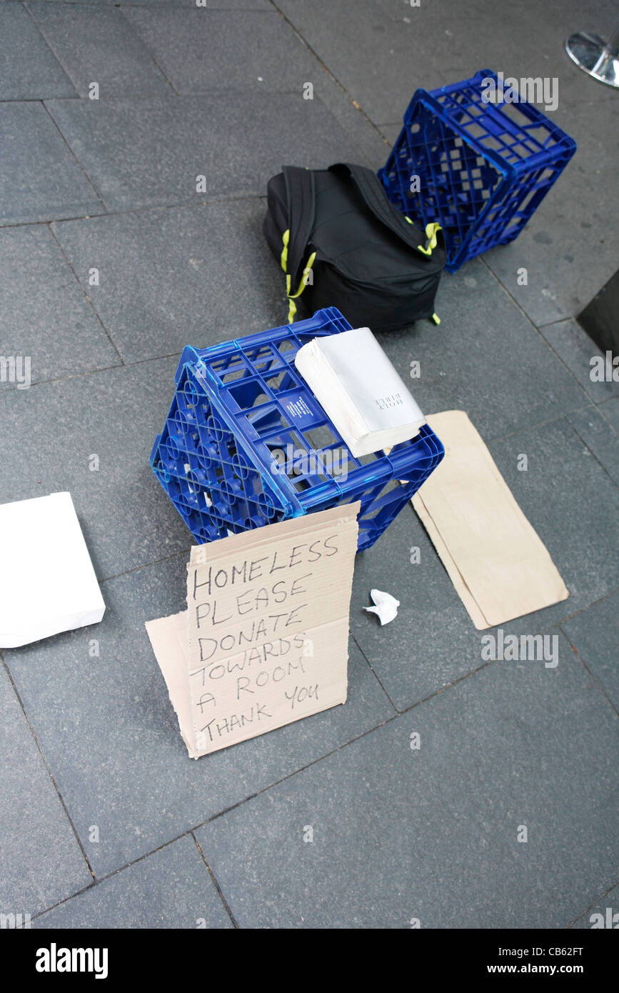 Homeless person sign on sidewalk Stock Photo - Alamy