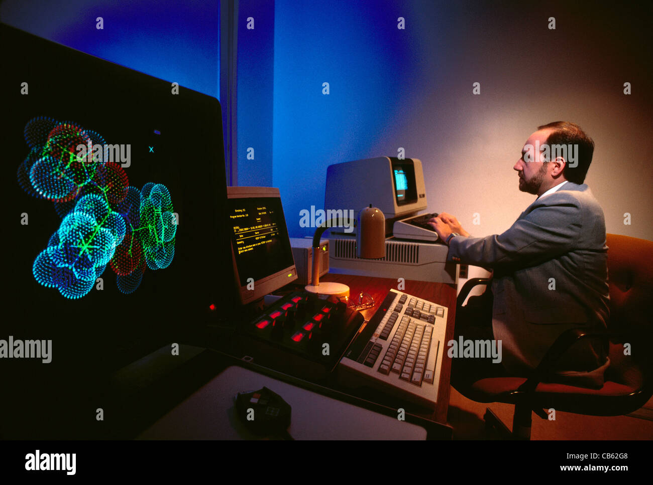Scientist studying a molecular model illustration on computer equipment ...