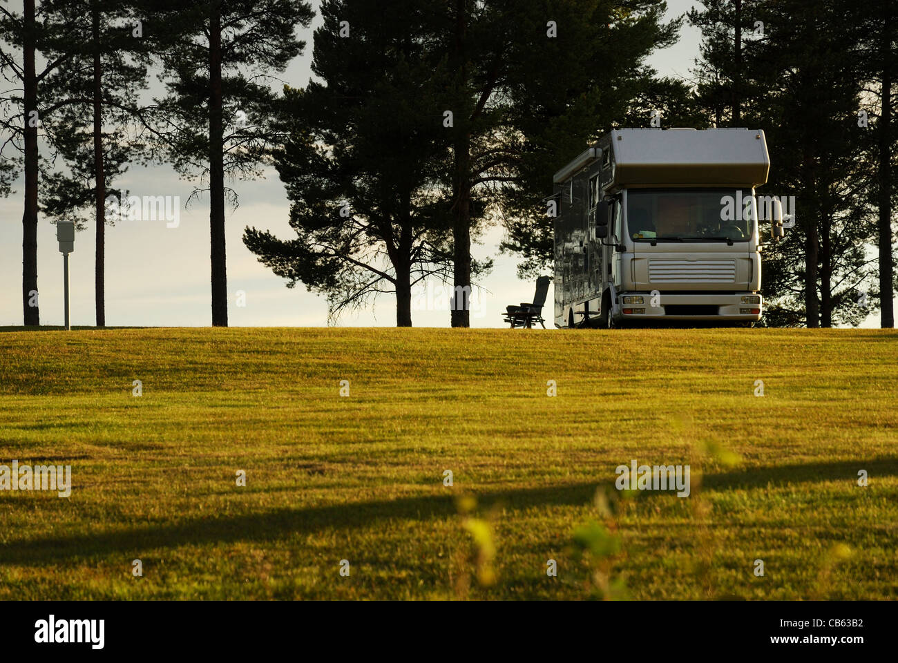 Mobile home on camping site into the sunset Stock Photo - Alamy