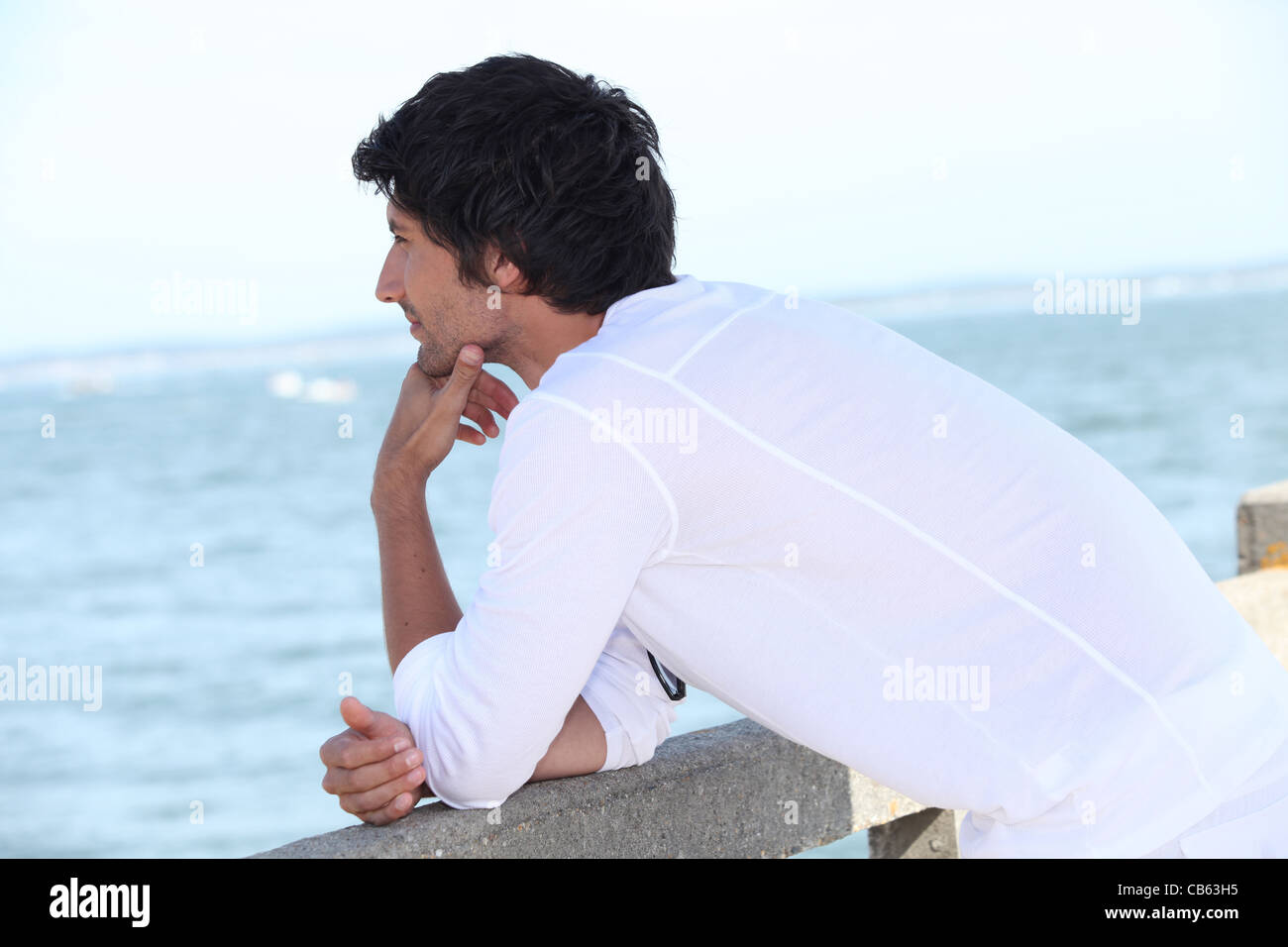 Young man watching horizon Stock Photo - Alamy