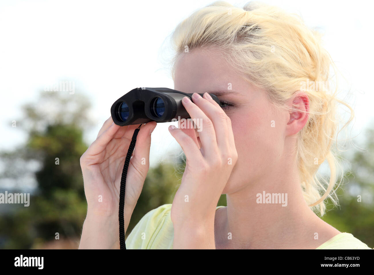 Young woman with binoculars Stock Photo - Alamy
