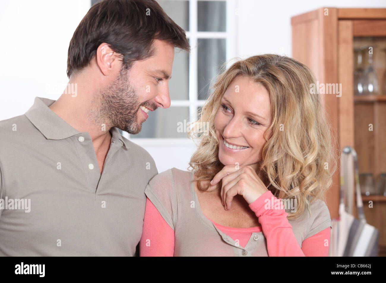 Couple flirting in kitchen Stock Photo - Alamy
