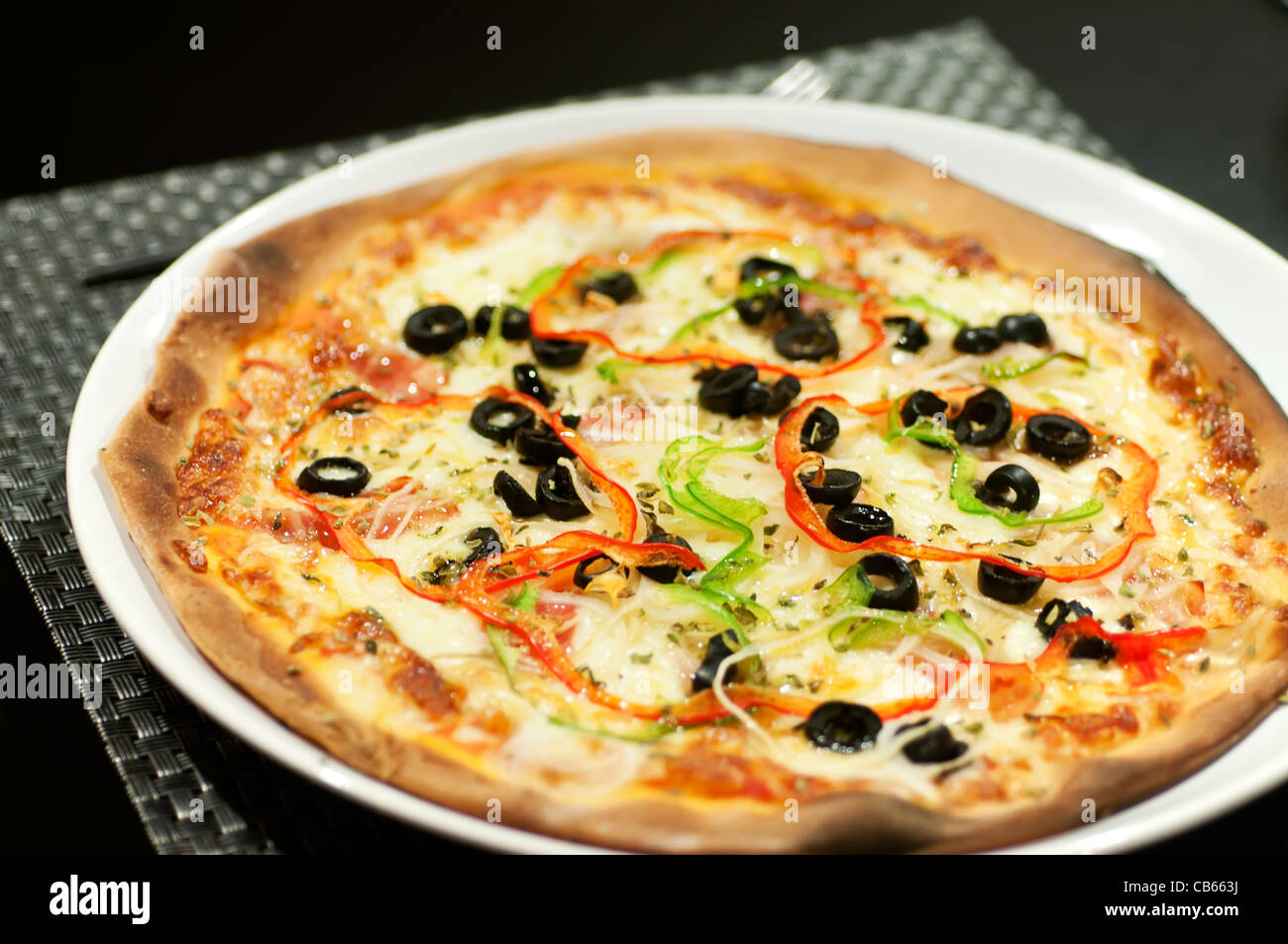 A pizza after cooking on the oven. Over a restaurant table Stock Photo ...