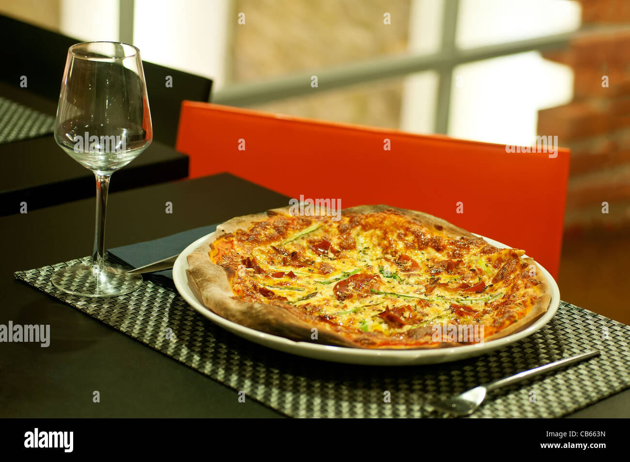 A pizza served at restaurant table Stock Photo - Alamy