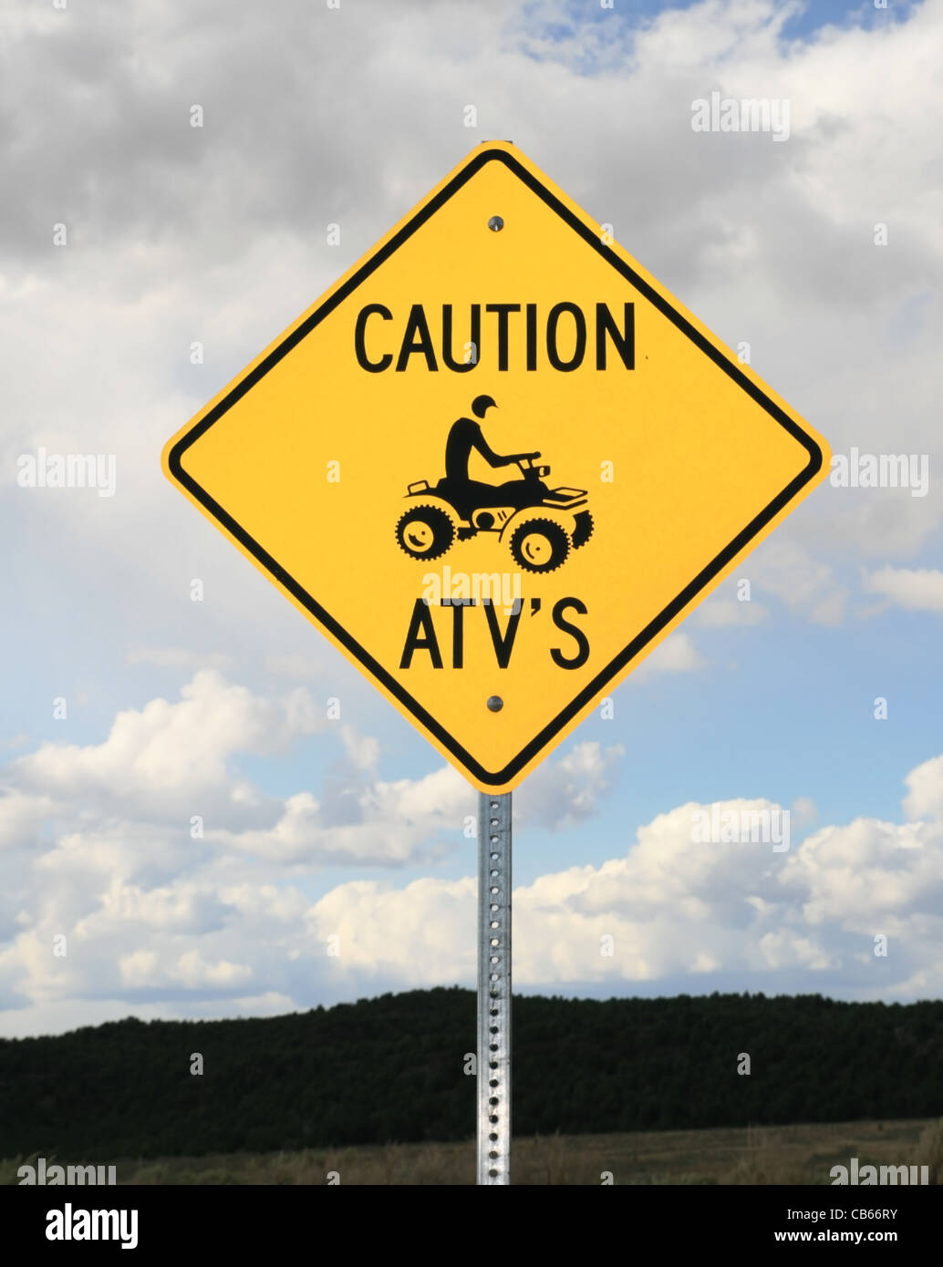 caution ATV (all terrain vehicle) sign with a cloudy sky behind Stock ...