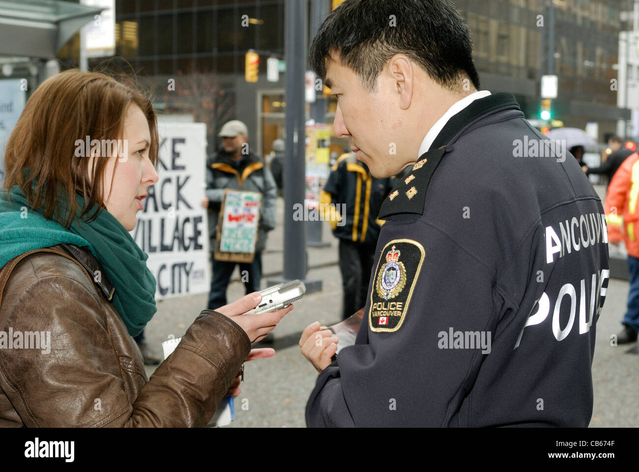 Vancouver Police Chief Jim Chu giving an interview to a street reporter ...