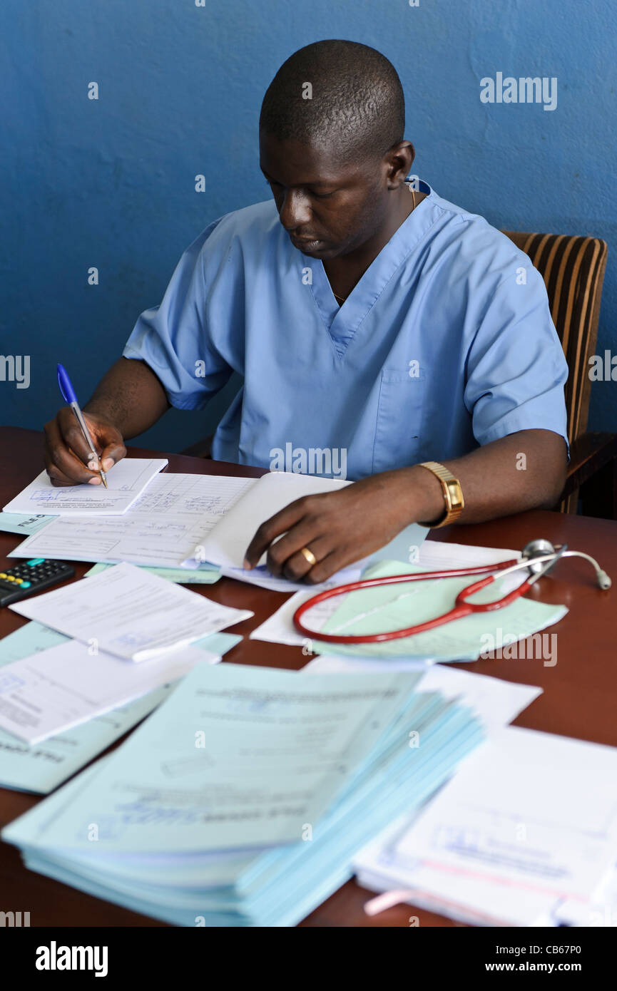 A young doctor writing patient notes in a hospital office, Freetown ...